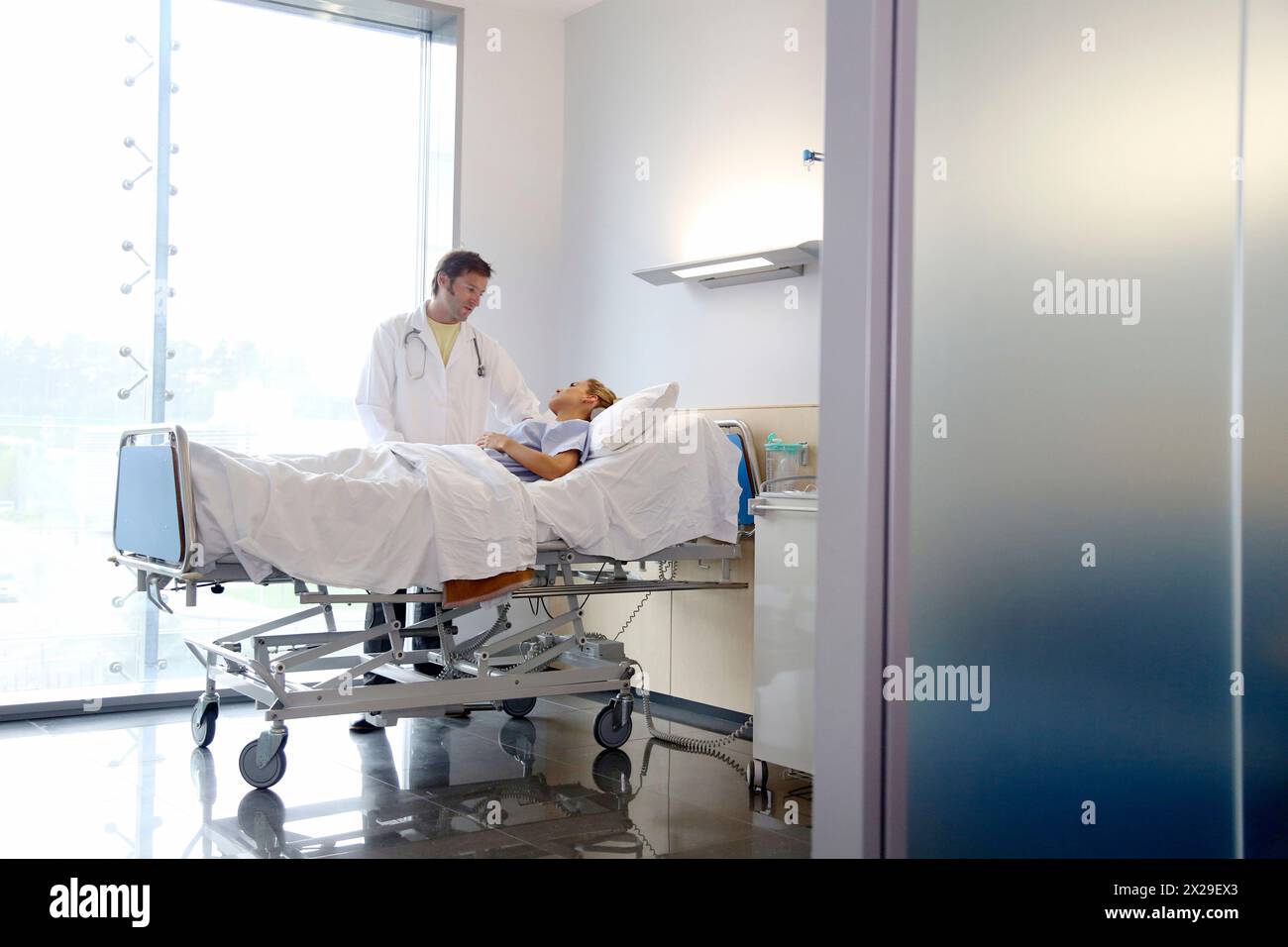 doctor attending to patient in hospital room, Onkologikoa Hospital ...