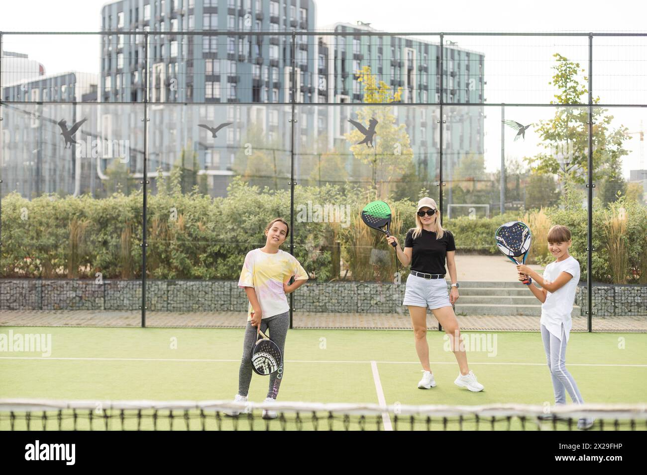 mother and daughters playing padel outdoor Stock Photo - Alamy