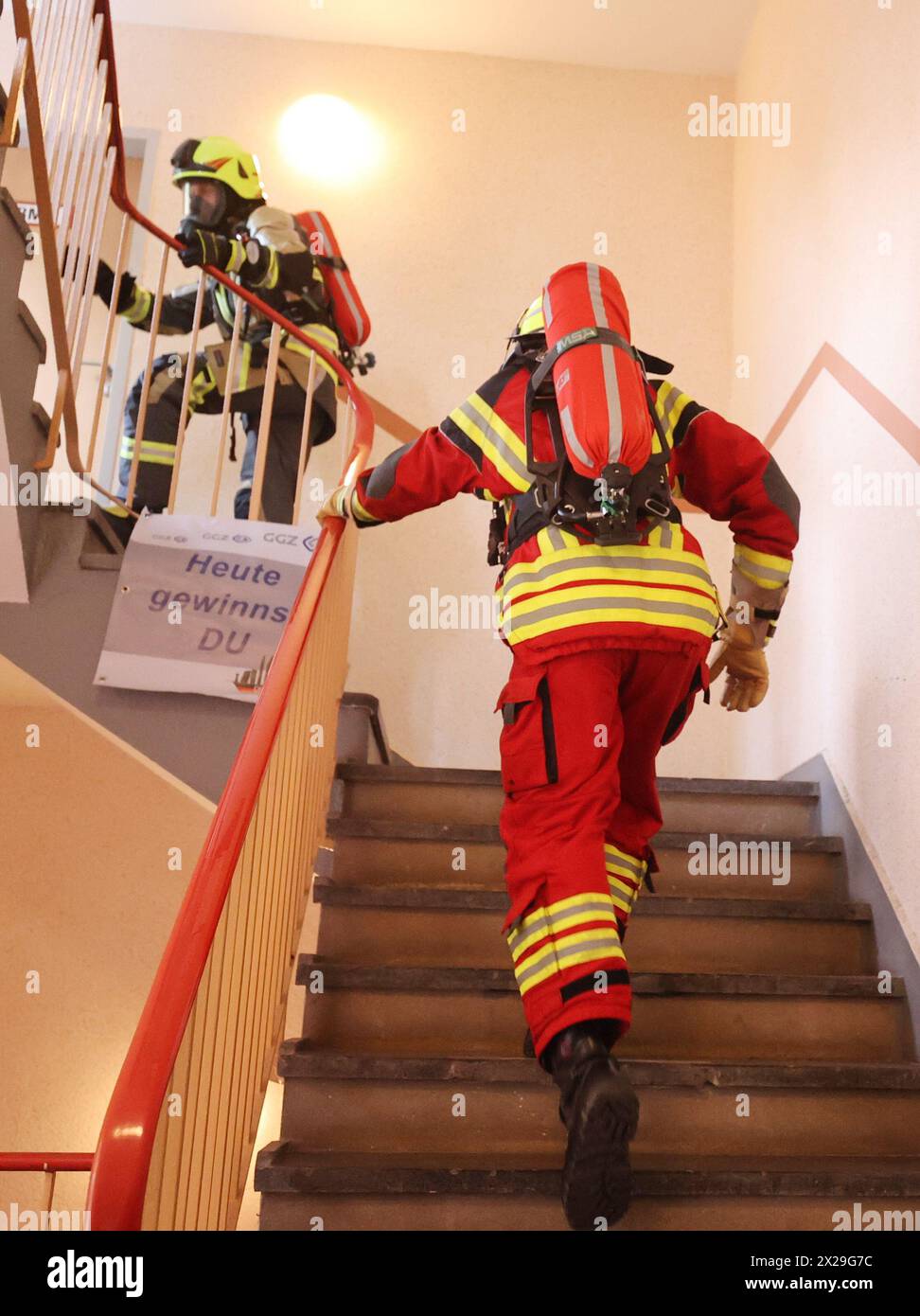 Zwickau, Germany. 21st Apr, 2024. Firefighters with breathing masks and ...