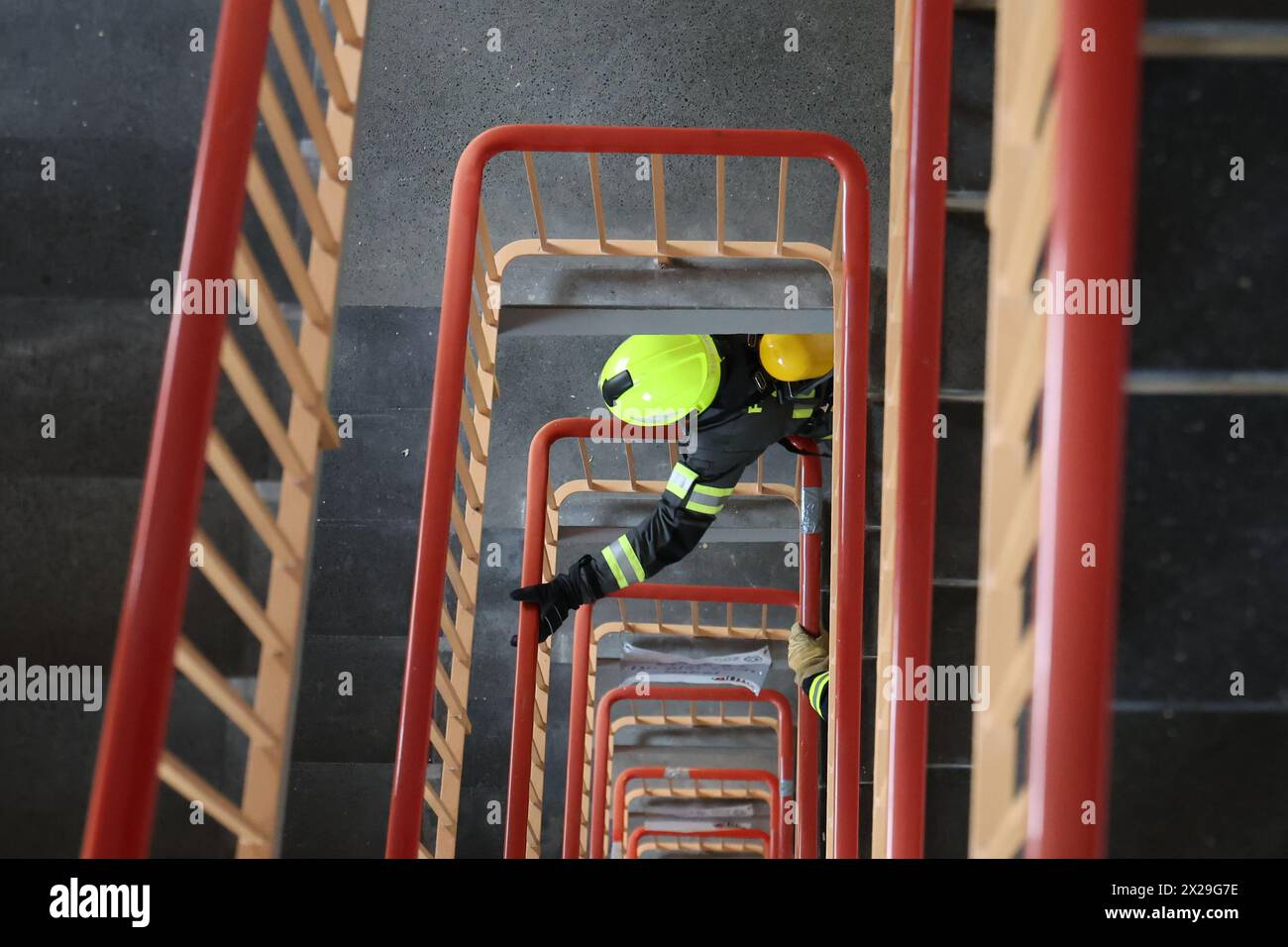 21 April 2024, Saxony, Zwickau: A firefighter with breathing mask and ...