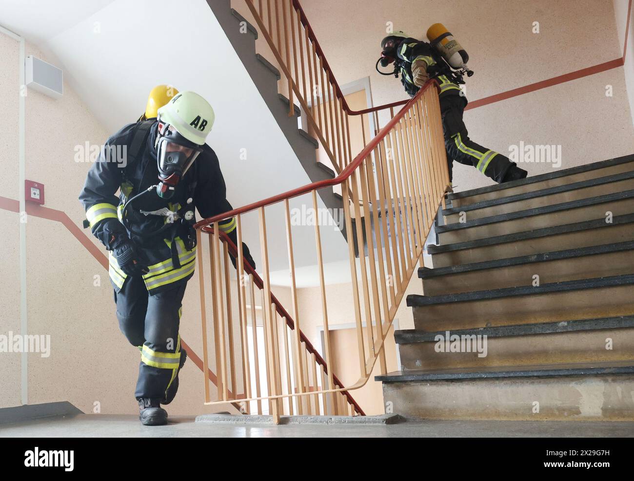 Zwickau, Germany. 21st Apr, 2024. Firefighters with breathing masks and ...