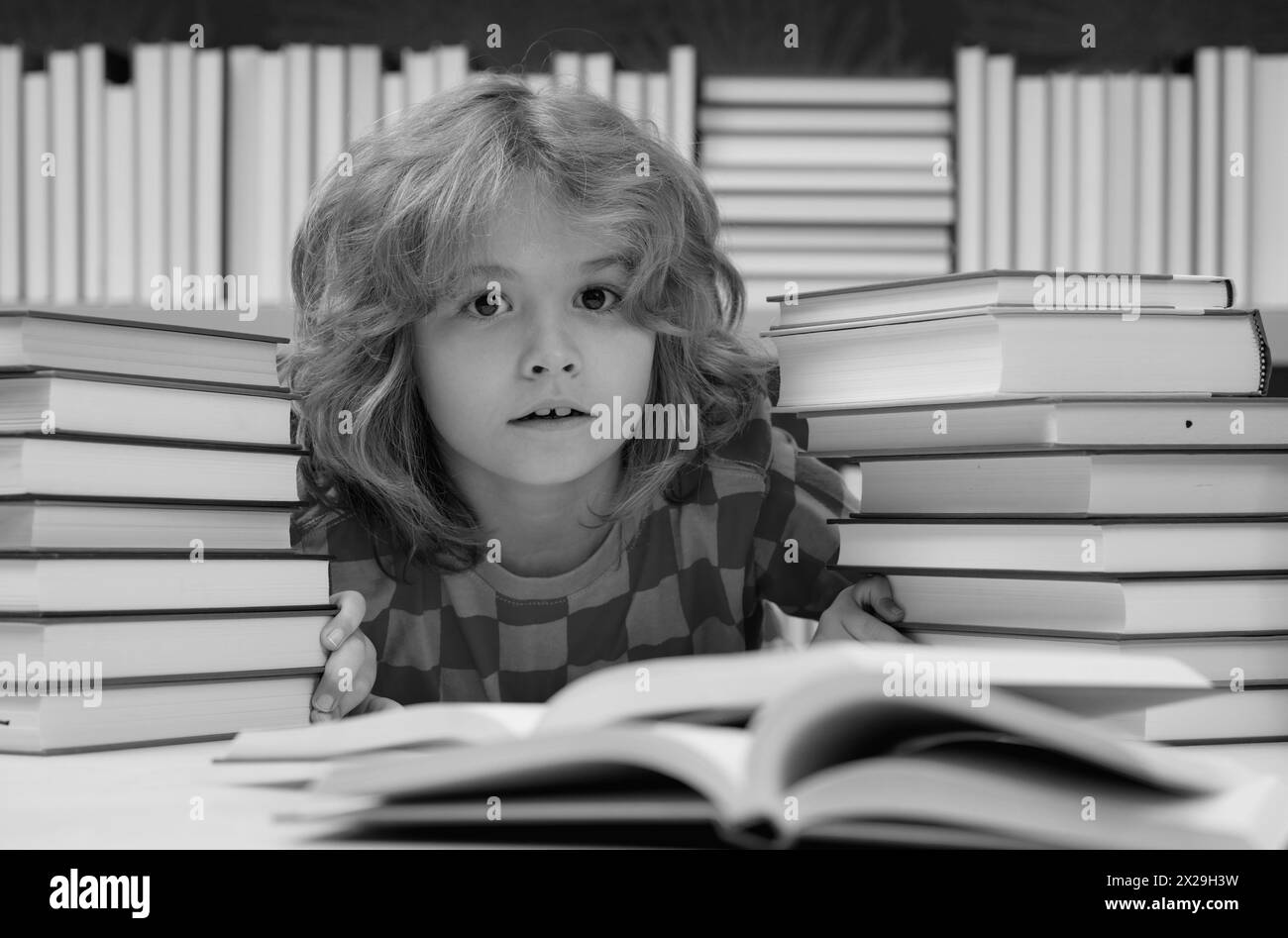 School boy reading book in library. Kids development, learn to read ...