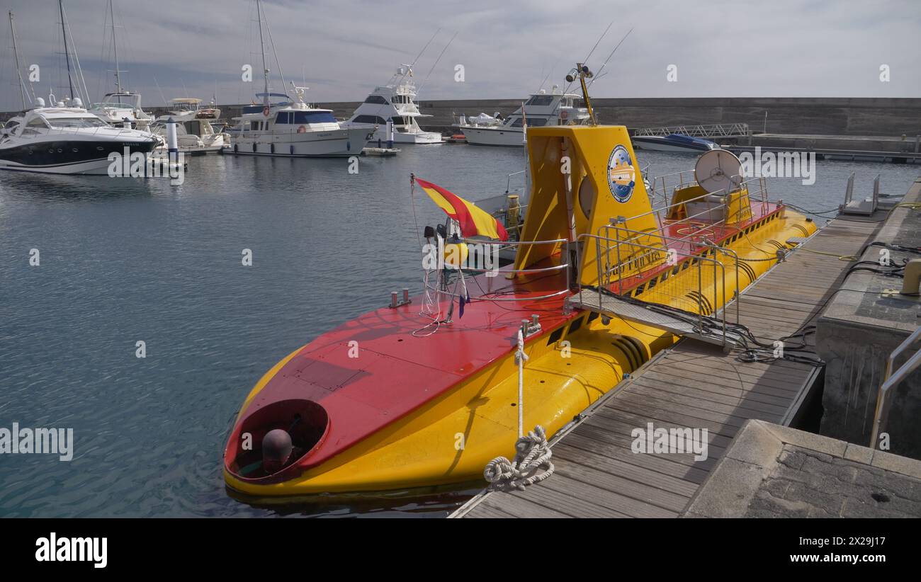 Puero Calero harbour Lanzarote. A yellow tourist submarine takes ...