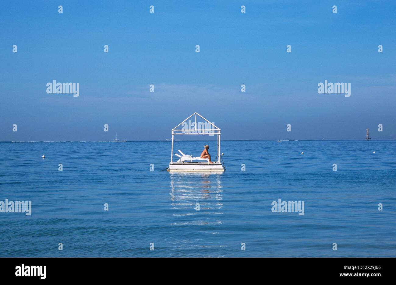 Tourist sunbathing on float, Sanur Beach, Bali, Indonesia Stock Photo ...