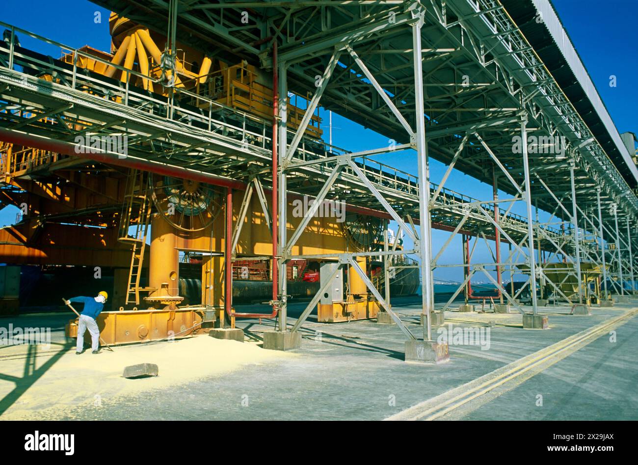 Man sweeping sulphur, Conveyors, PKG Jetty, Surabaya, Indonesia Stock ...