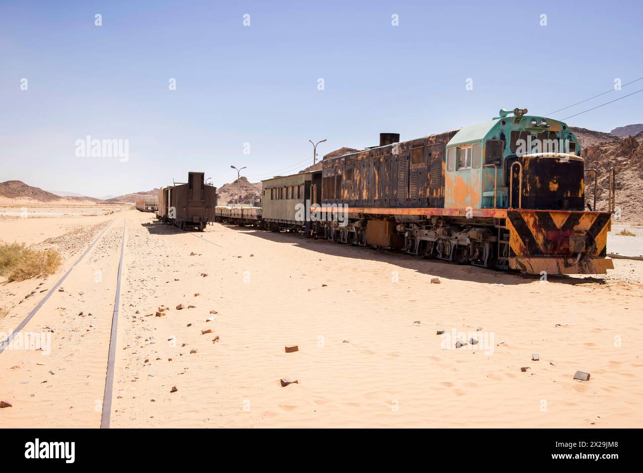 the hijaz railway station, steam train and tracks in the desert at wadi ...