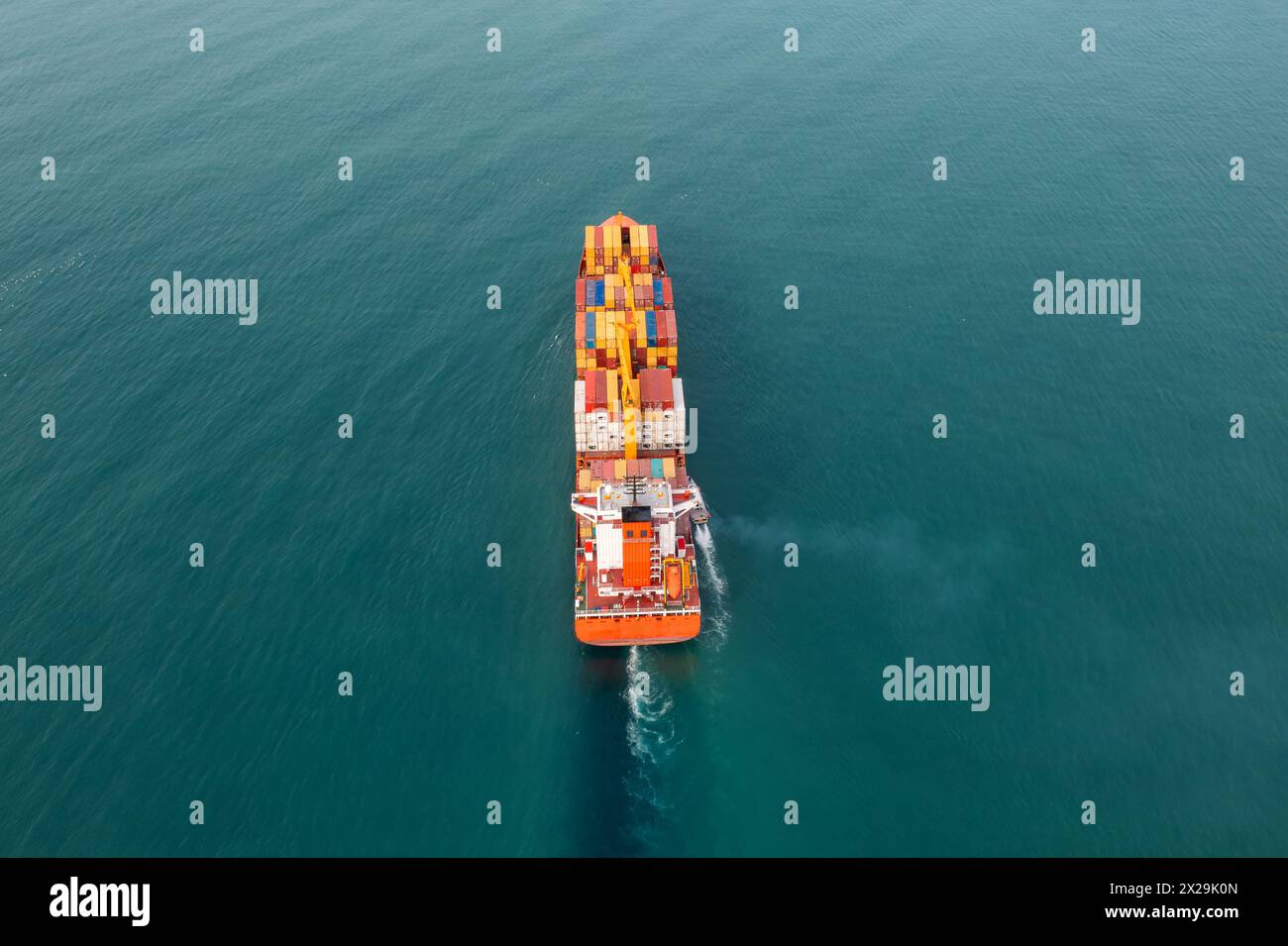 Aerial back view of cargo ship carrying containers for import and export, business logistic and ...