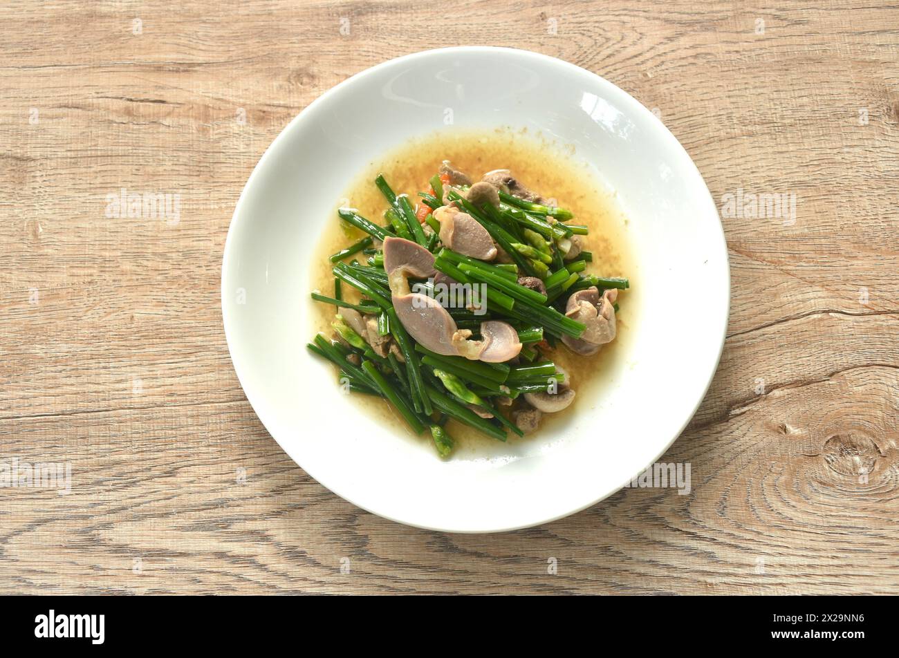 stir fried garlic chives with chicken organ on plate Stock Photo - Alamy