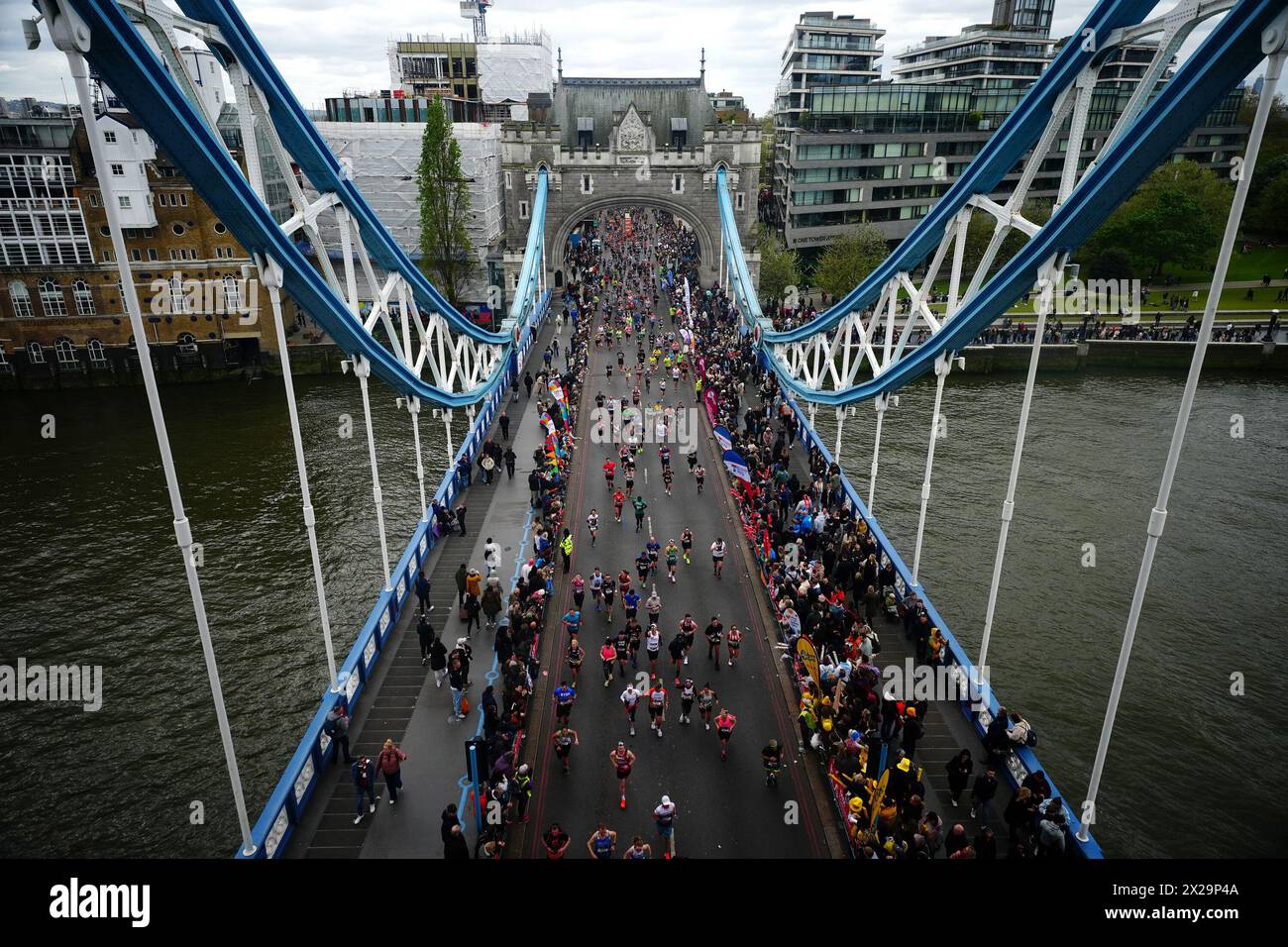 Runners cross Tower Bridge during the TCS London Marathon. Picture date ...