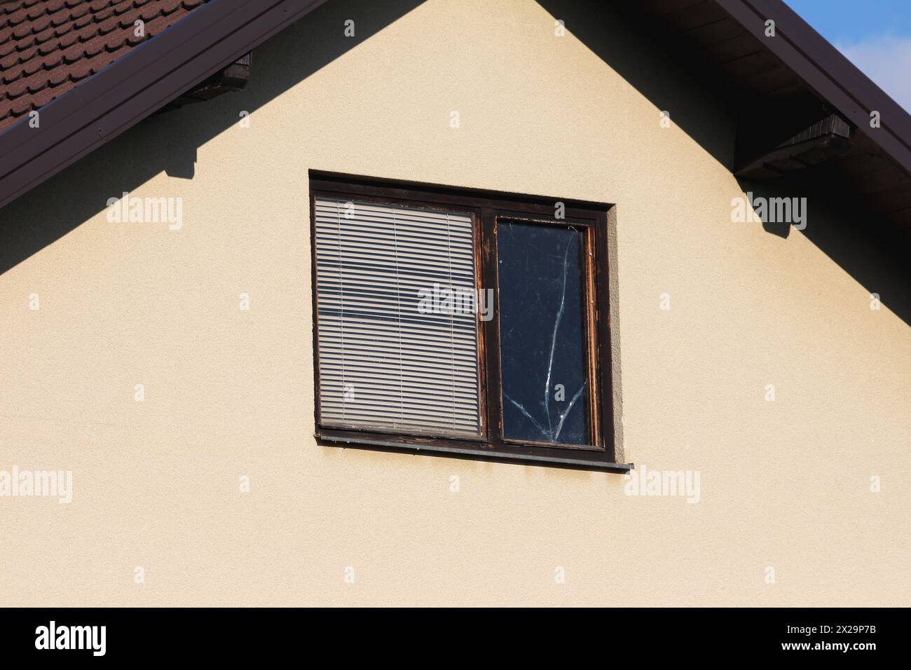 Attic window with dilapidated cracked wooden frame and closed window ...
