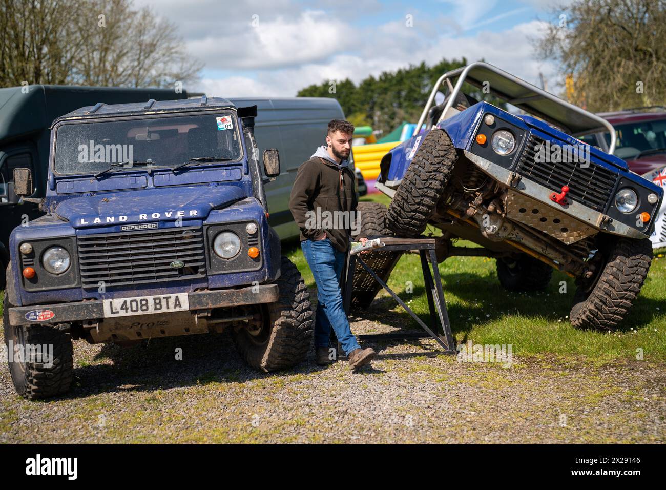 A man walks between two muddy Land Rovers during the Great British Land ...