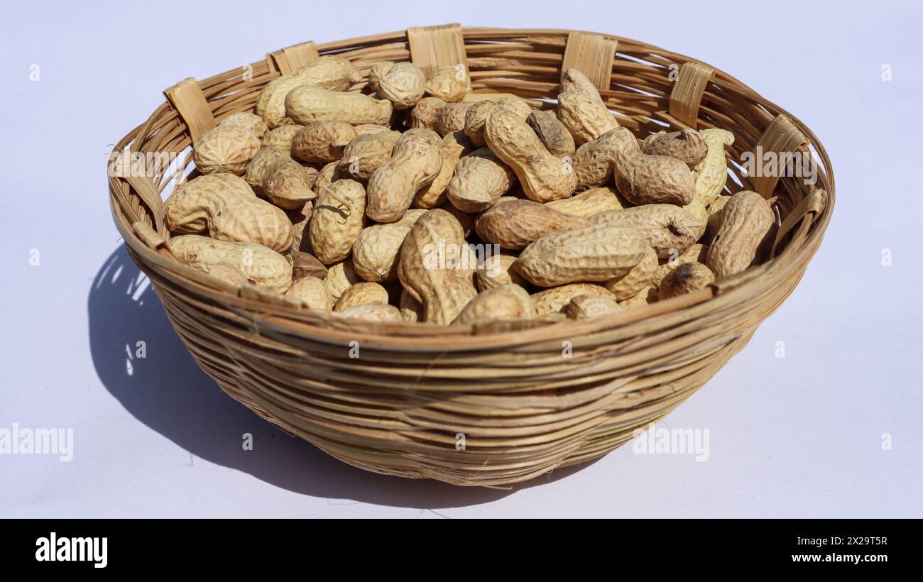 Fresh raw Groundnuts unpeeled in wicker Basket. Shelled Peanuts in heap ...