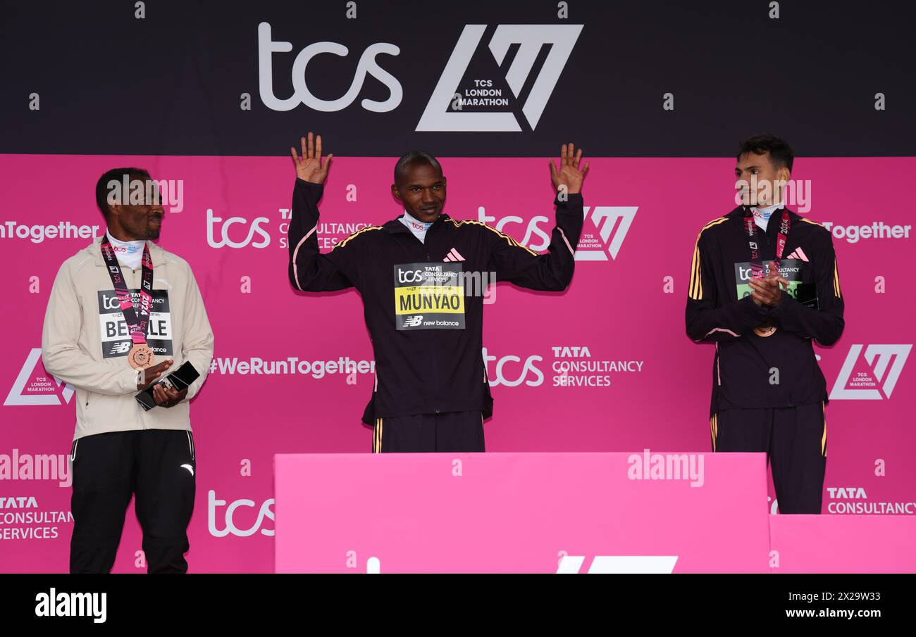 From left, Kenenisa Bekele, Alexander Mutiso Munyao and Emile Cairess on the podium after the ...