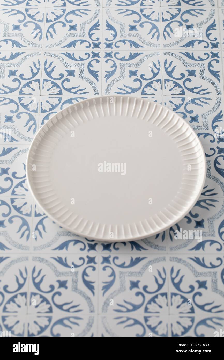 Classic white ceramic plate on a beautifully patterned blue and white ...