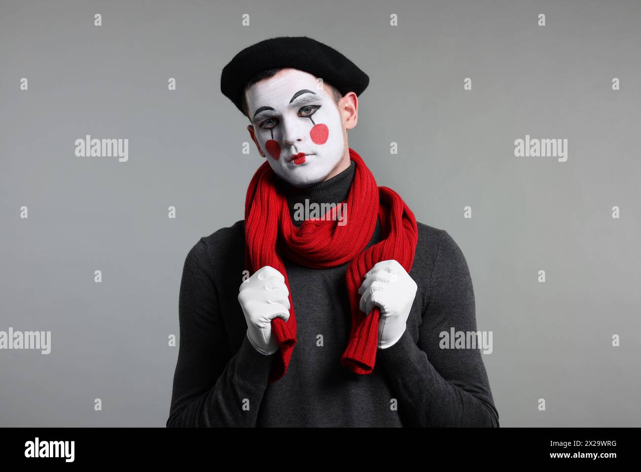 Portrait of mime artist in beret on grey background Stock Photo - Alamy