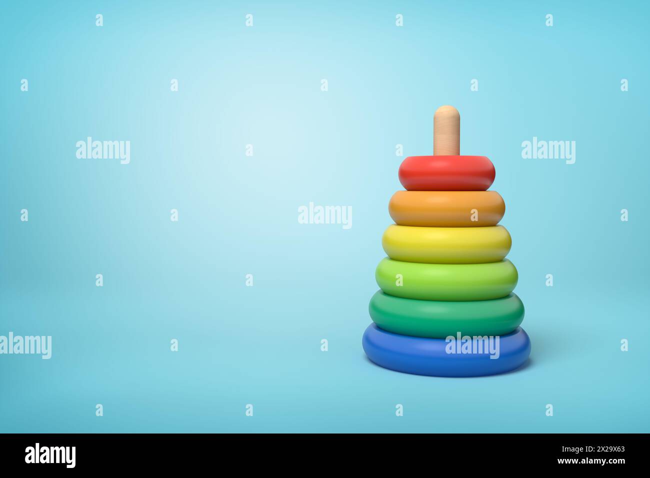 Brightly colored stacking rings on a soft blue background Stock Photo ...