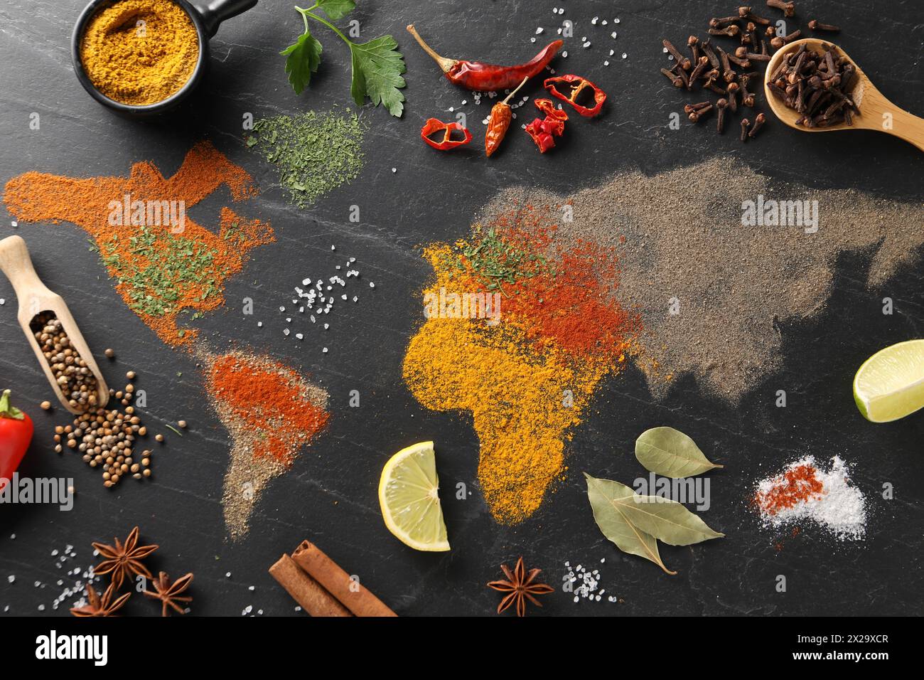 World map of different spices and products on dark textured table, flat ...