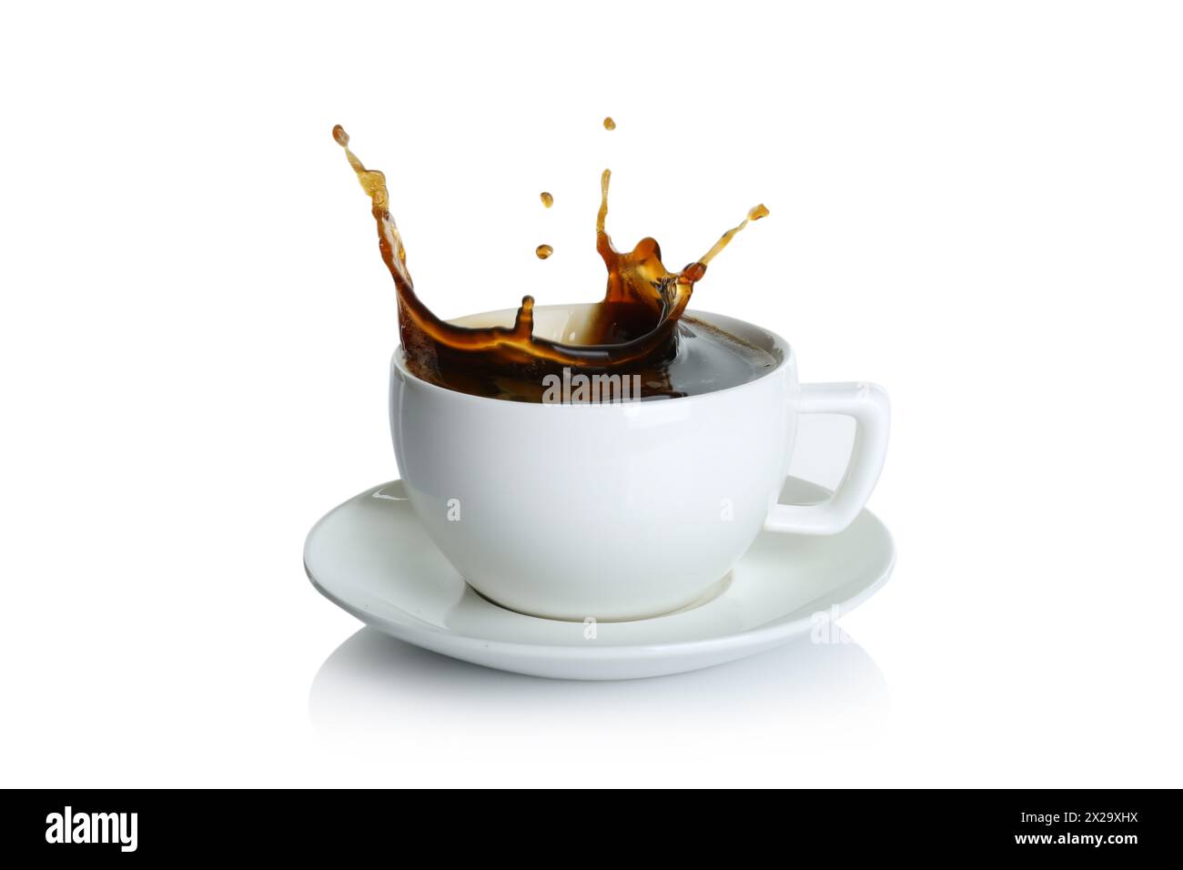 Coffee splashing in cup on white background Stock Photo - Alamy