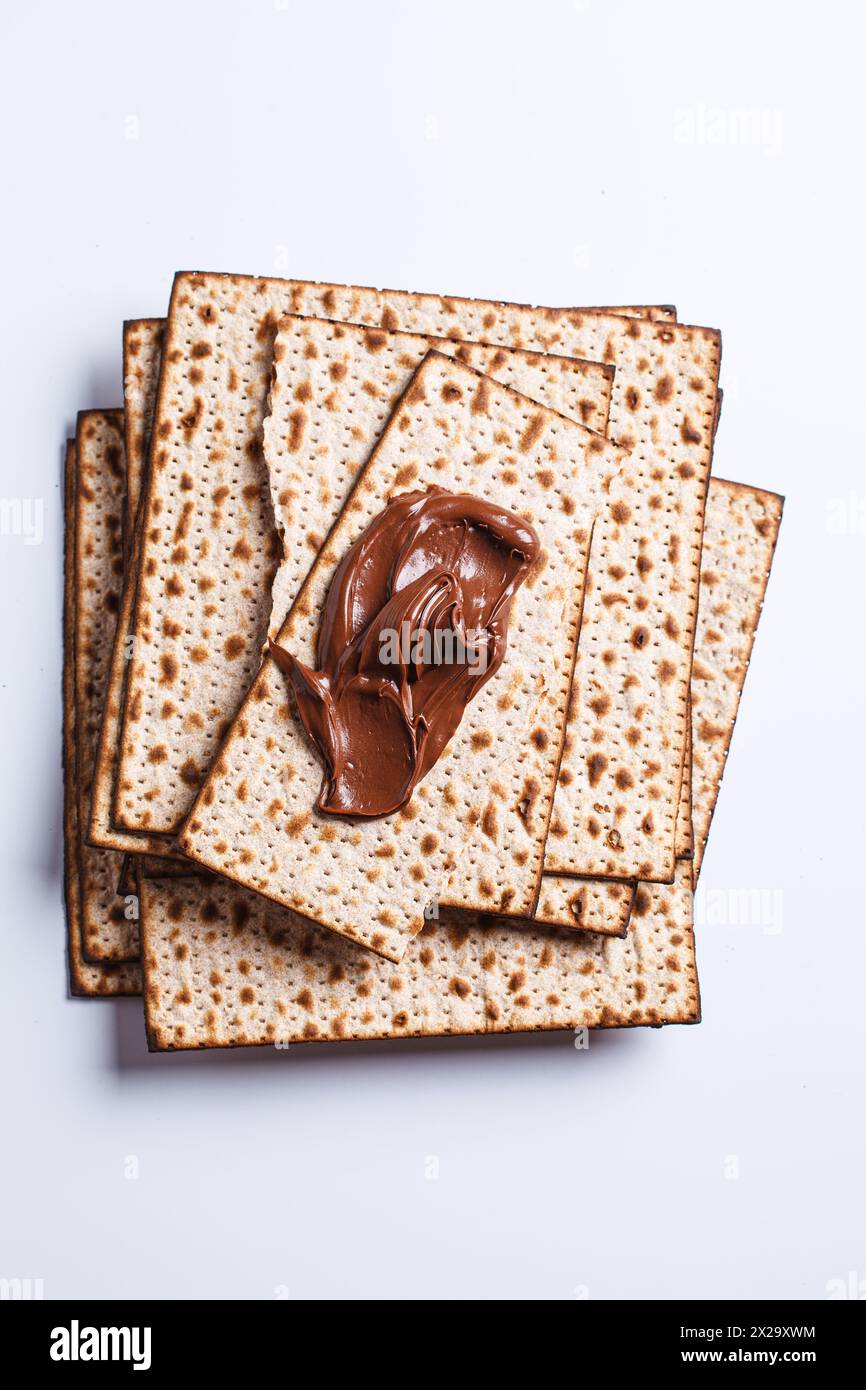 Matzo with chocolate spread on a white background. Traditional bread ...