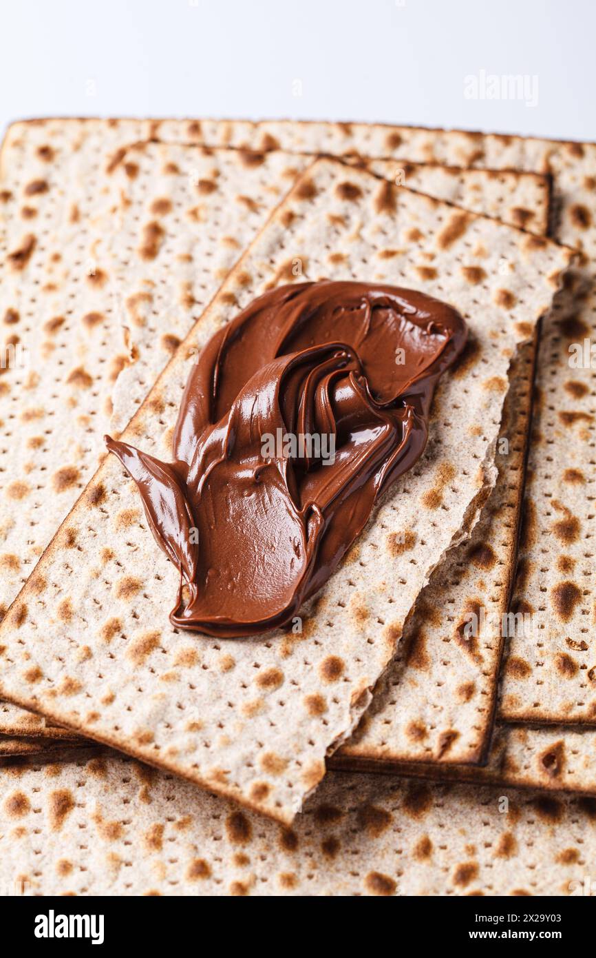 Matzo with chocolate spread on a white background. Traditional bread ...