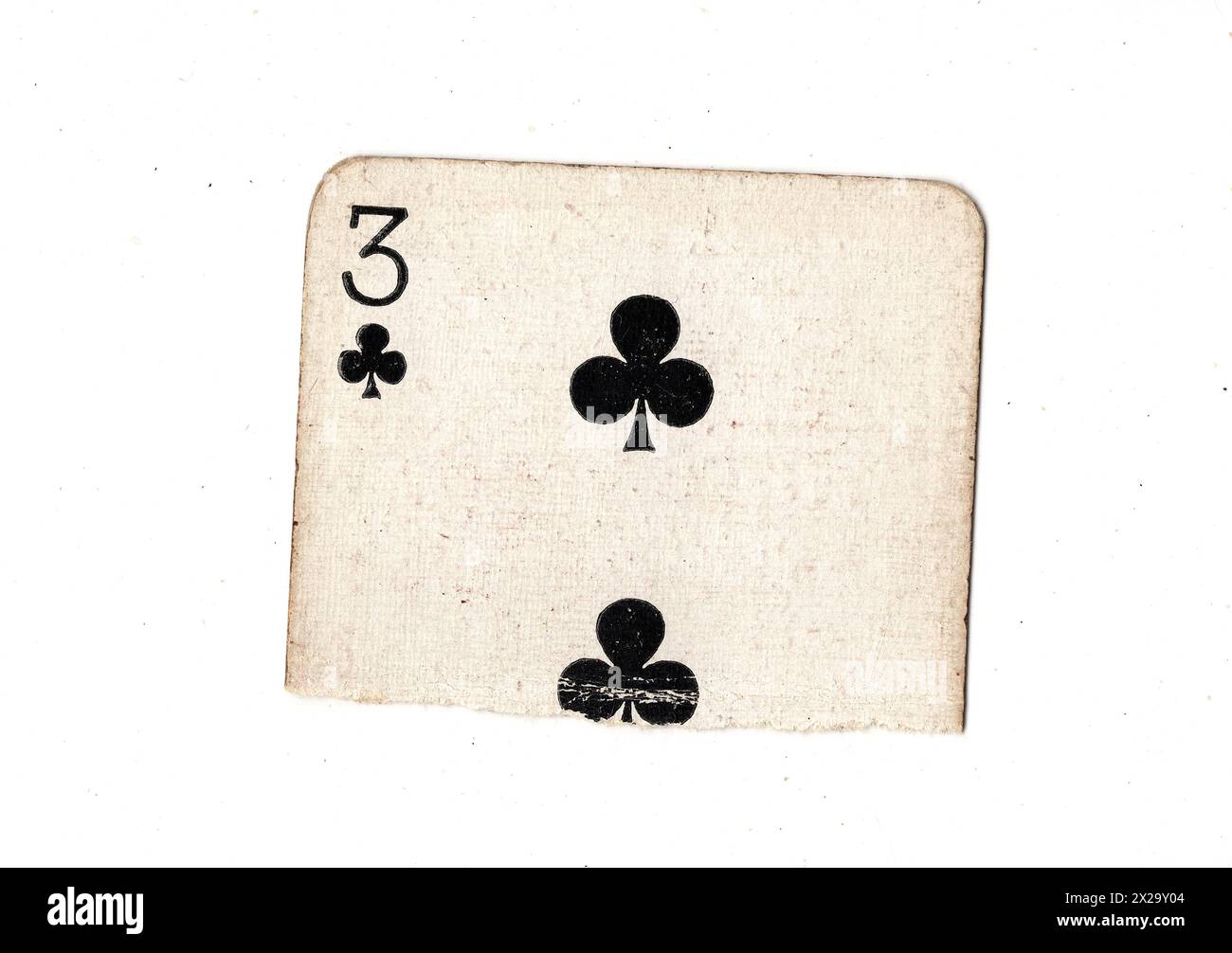 A torn half of a vintage, well used three of clubs playing card ...