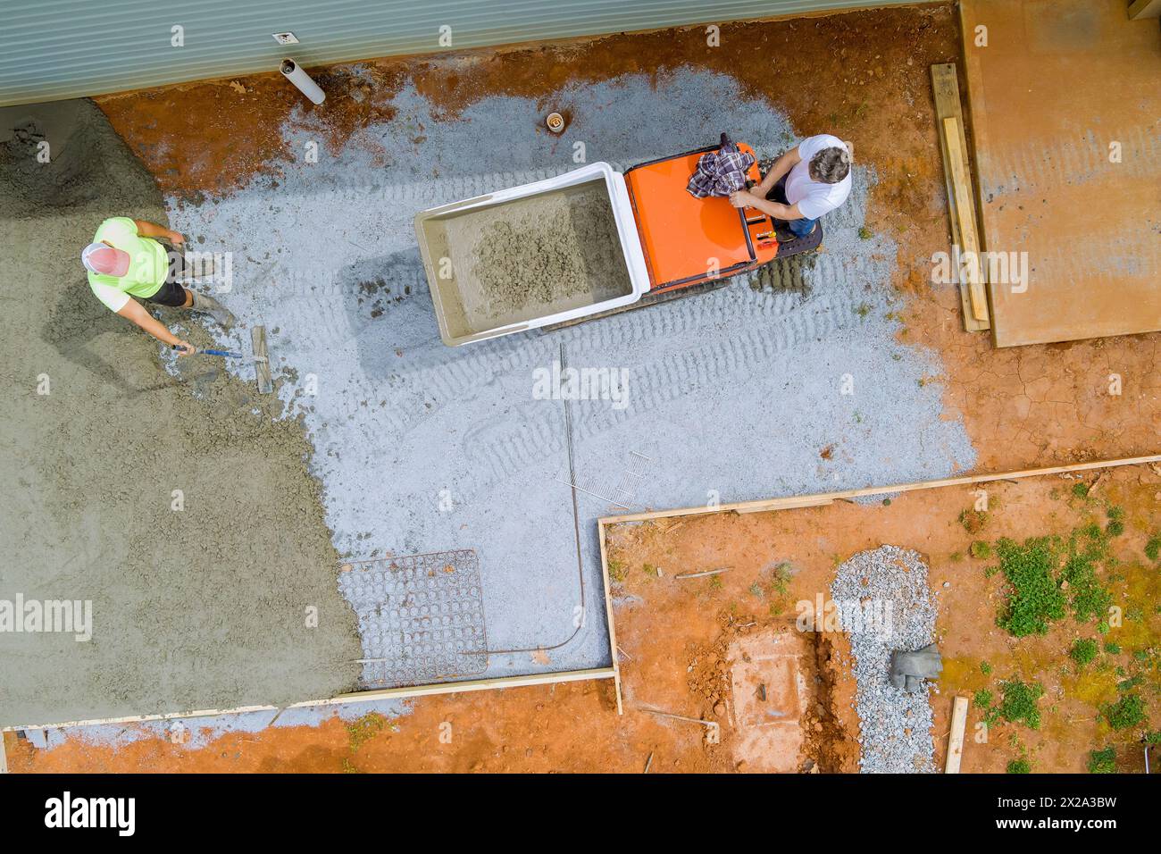Wet cement is poured into framework using self dumping track concrete ...