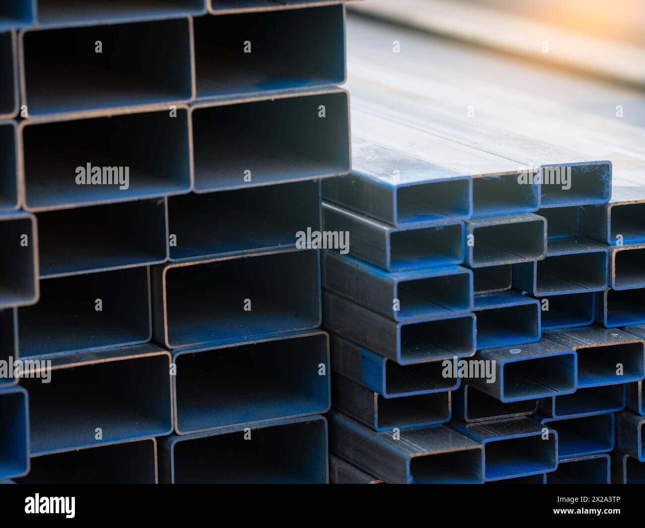 Industrial warehouse stock of rectangular metal pipes for building and construction supplies ...