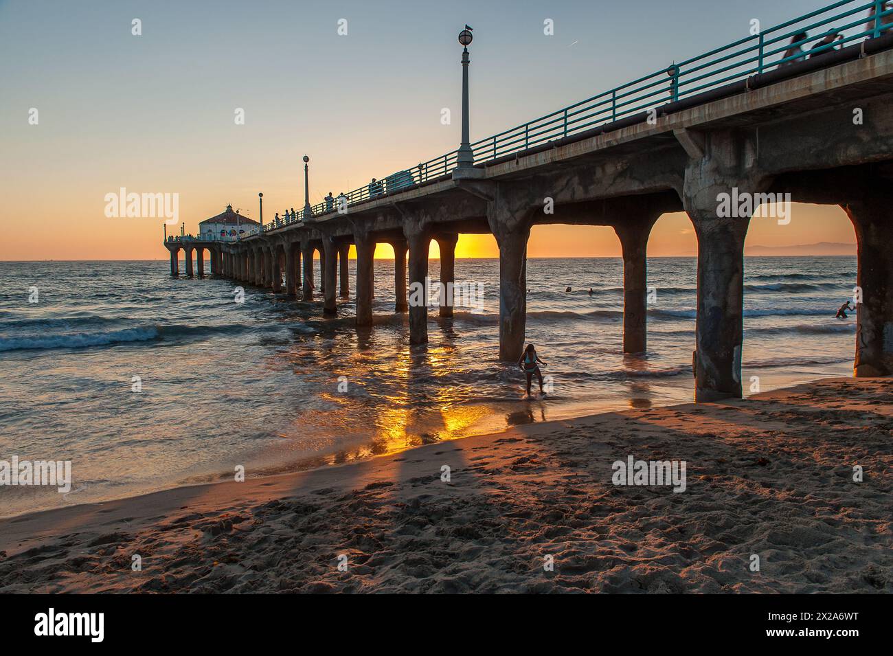 People enjoy sunset at Manhattan beach on the pacific coast beach in ...
