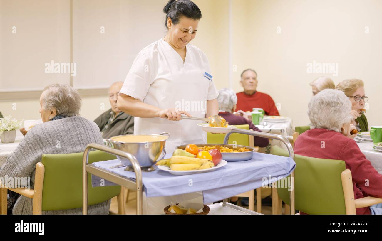Friendly cook serving food to seniors in nursing home Stock Photo - Alamy