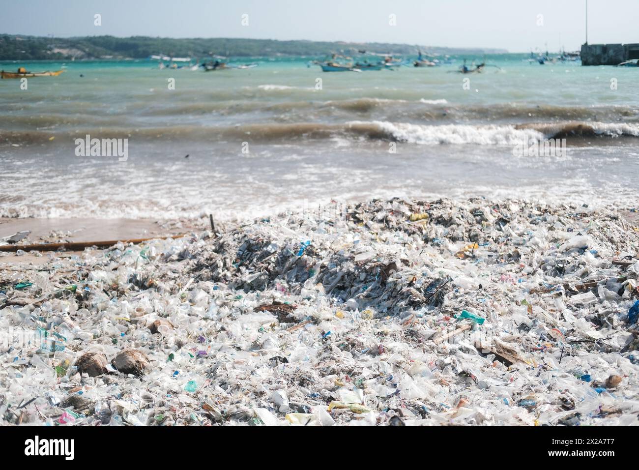 Sandy beach polluted with plastic waste. Global environmental disaster ...