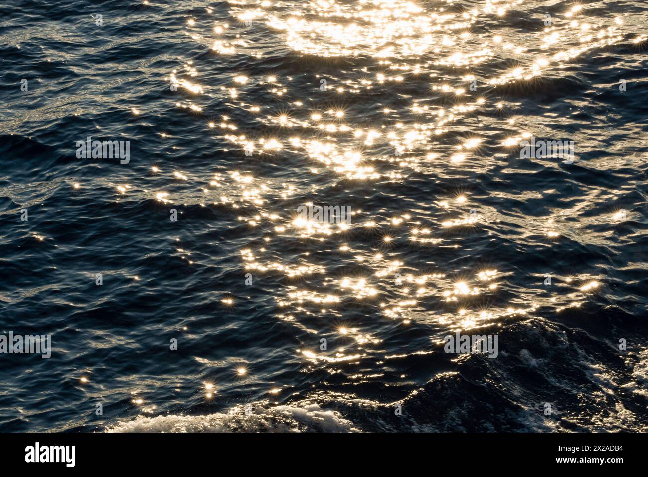 Lens star formed on water body on a sea, A calm ocean reflects sun ...