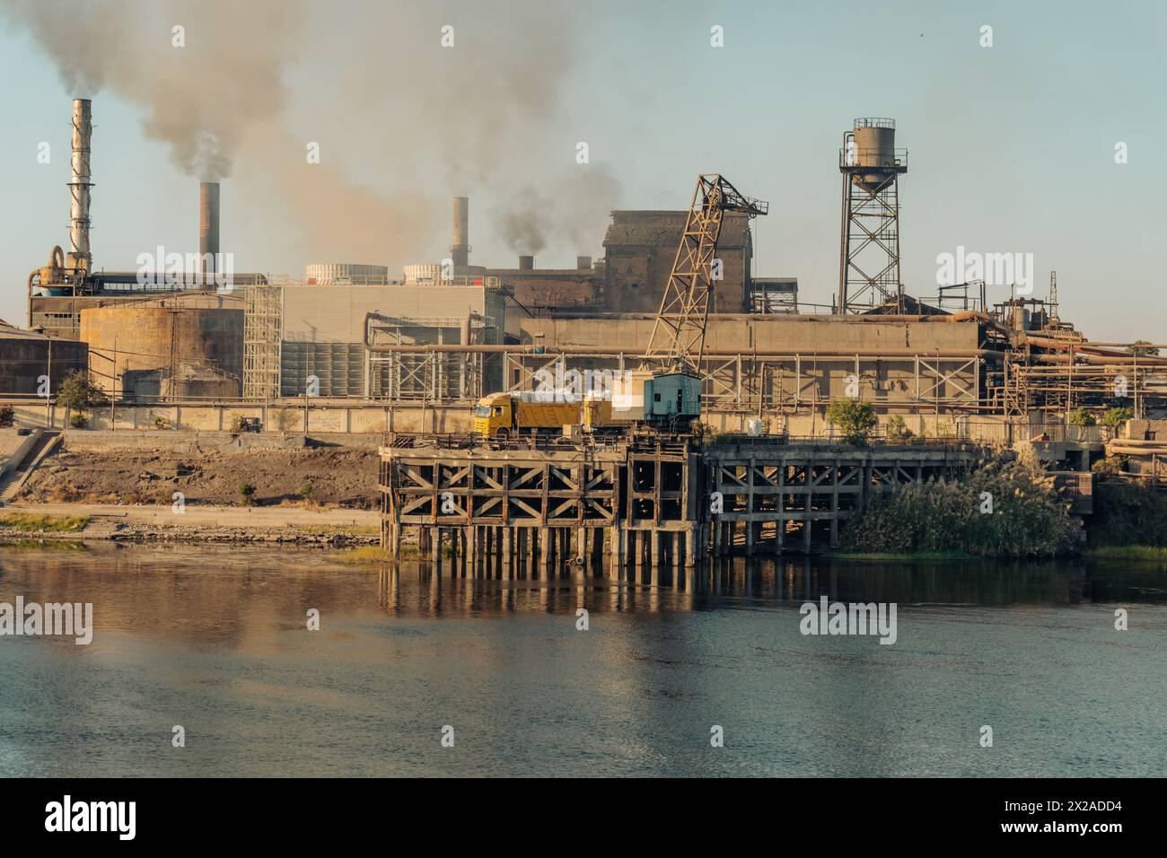 Black smoking sugar factory on the banks of the Nile Stock Photo - Alamy