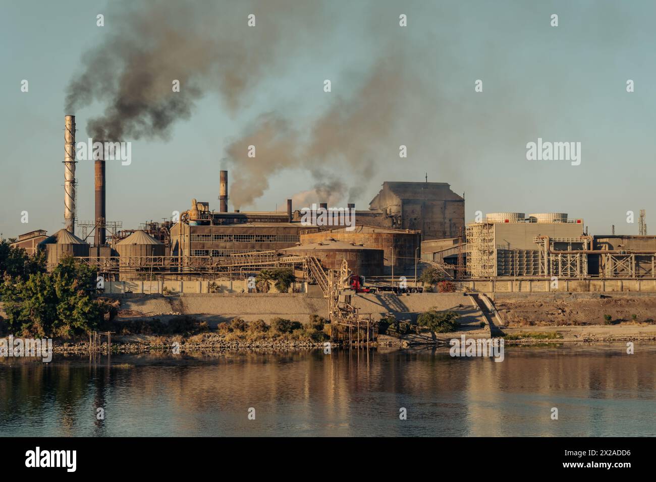 Black smoking sugar factory on the banks of the Nile Stock Photo - Alamy