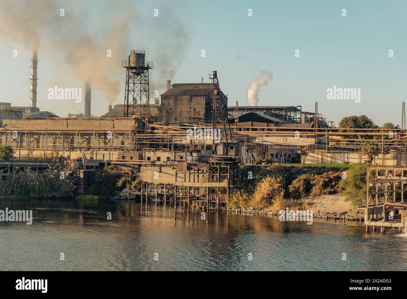Black smoking sugar factory on the banks of the Nile Stock Photo - Alamy