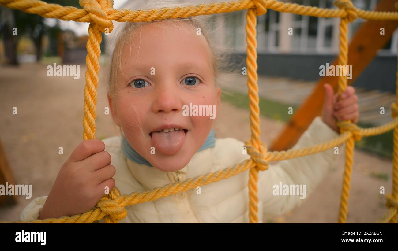 Little girl playground playful show tongue pampering fun smiling ...
