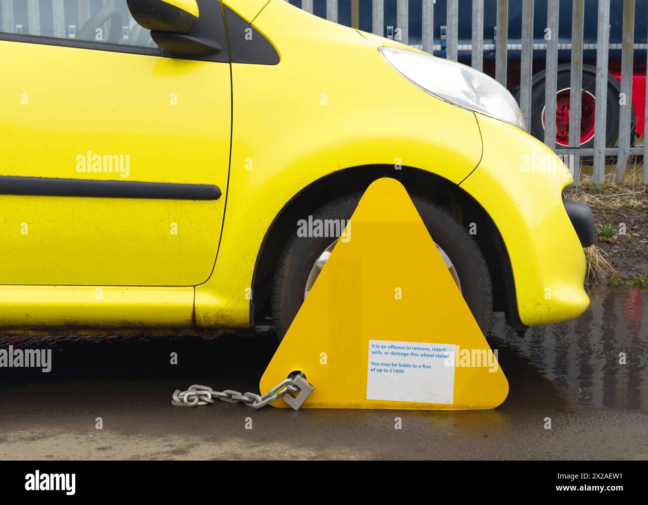 Car wheel clamped at restricted parking area Stock Photo - Alamy