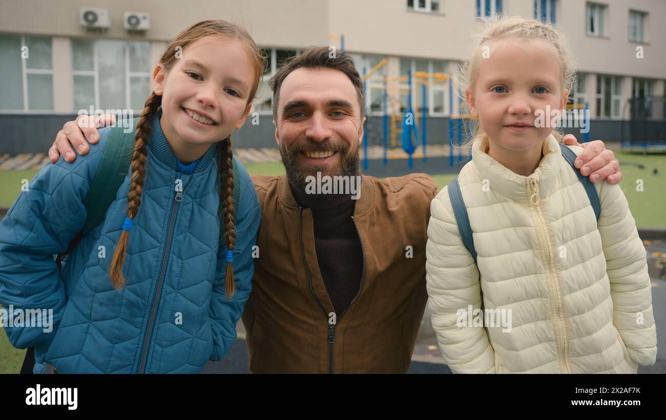 Happy family man two girls dad daughters schoolgirls students primary ...