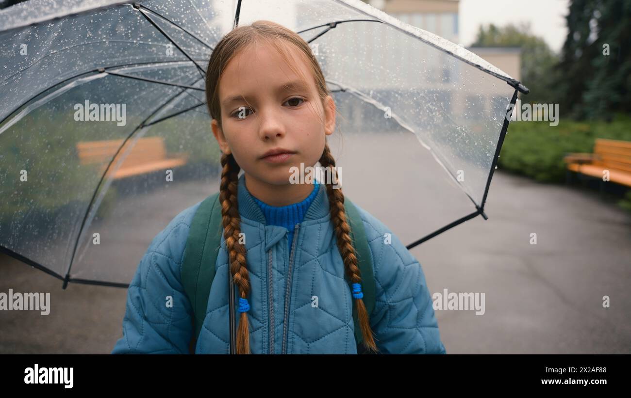 Tired little girl schoolgirl child looking at camera bored unhappy bad ...