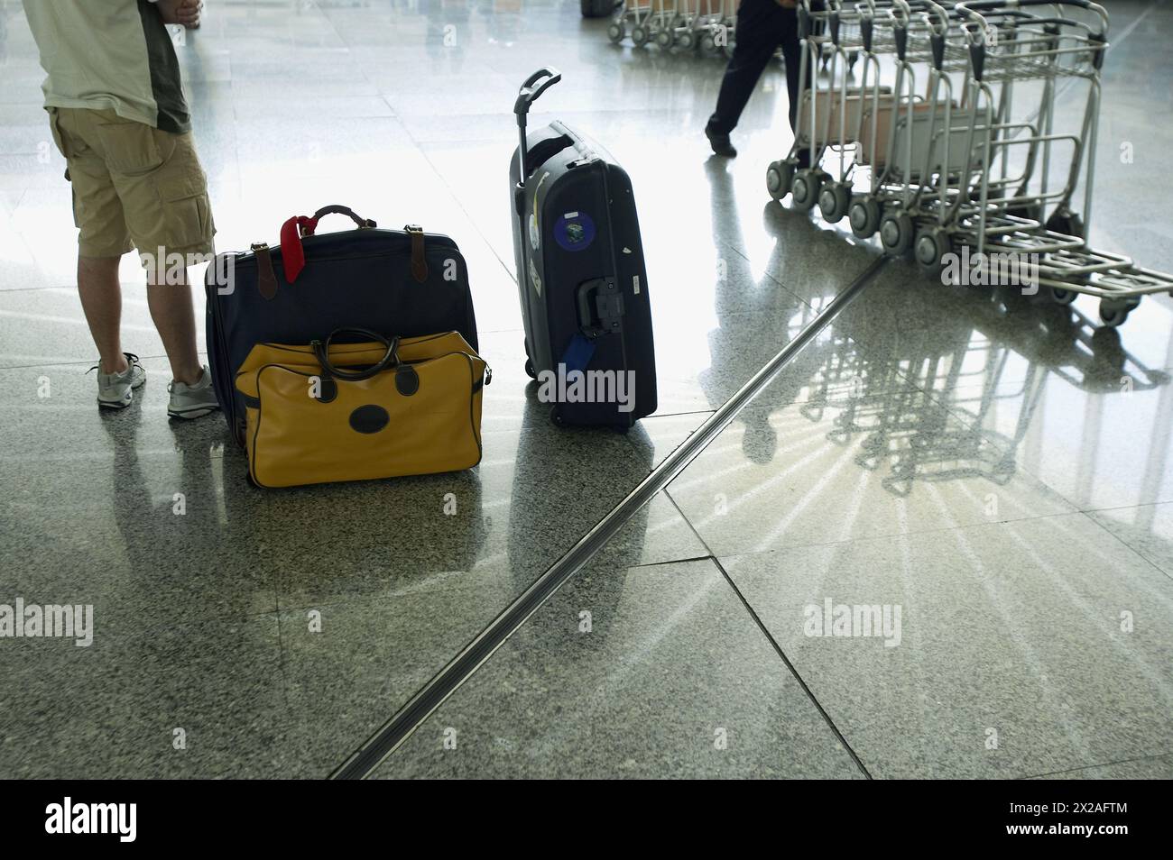 Traveler with suitcases in the Bilbao airport by Santiago Calatrava ...