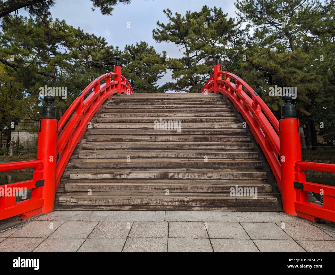 the red wooden drumbridge overlooking the steps at sumiyoshi temple in ...