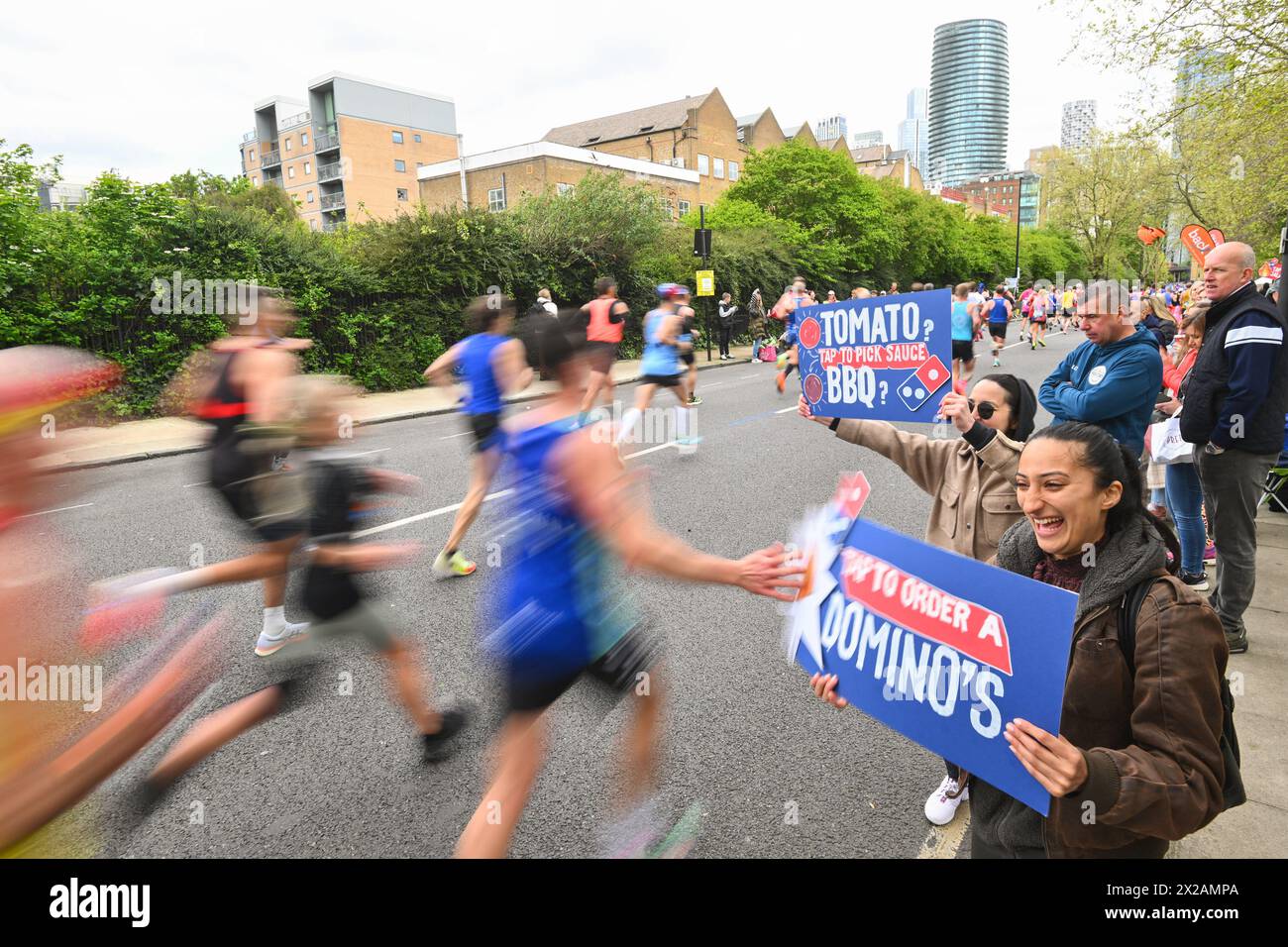 EDITORIAL USE ONLY A runner taps a sign to order their Domino's pizza ...