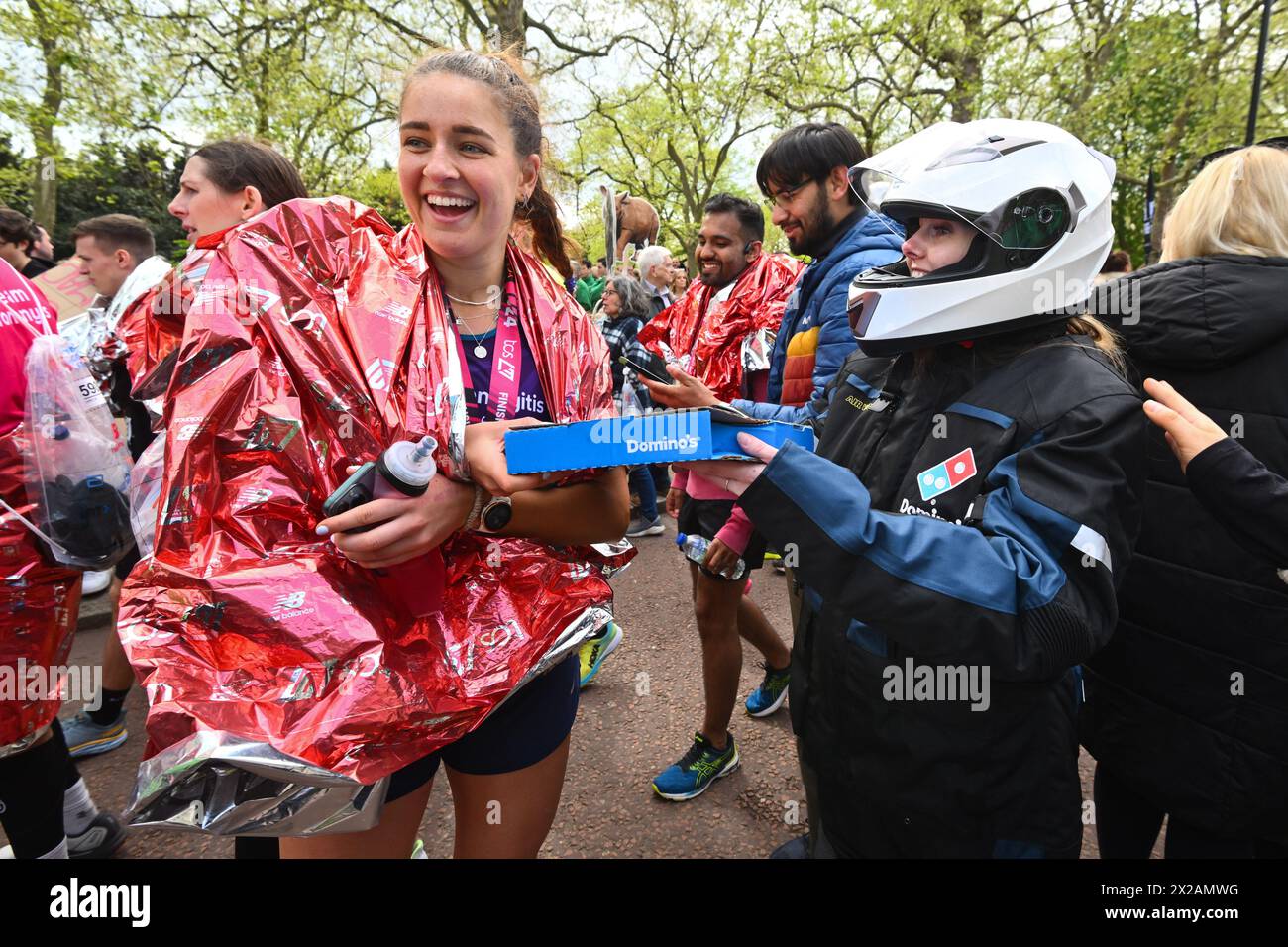 EDITORIAL USE ONLY Runner Emma from Surrey receives her Domino's pizza ...