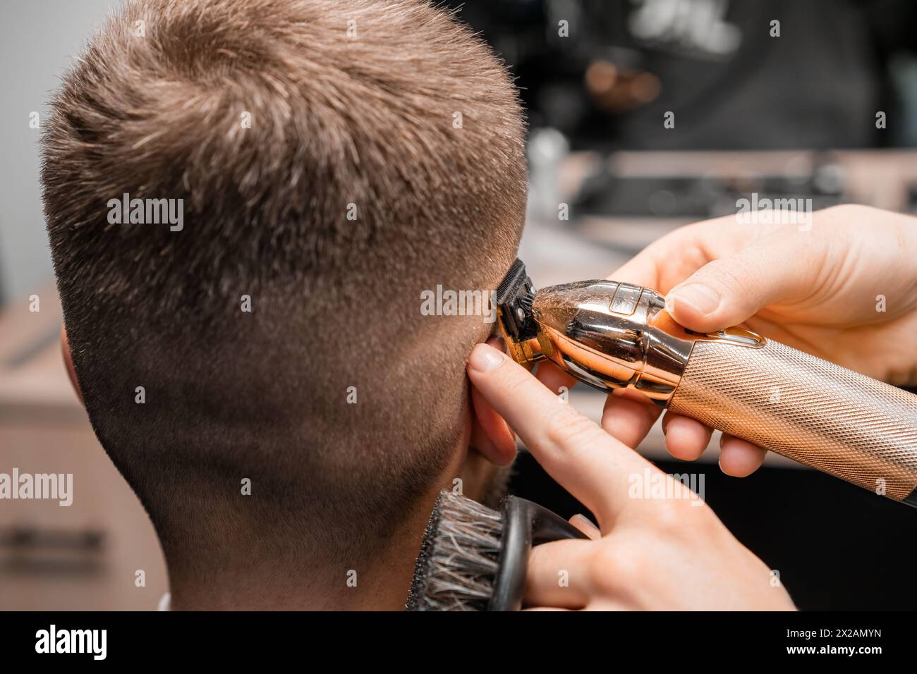 Hairstylist shaves male occiput hi-res stock photography and images - Alamy