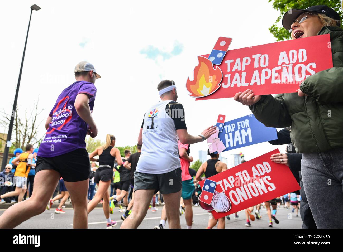 EDITORIAL USE ONLY A runner taps a sign to order their Domino's pizza ...