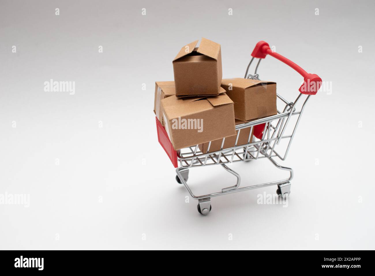 Cardboard boxes in a small shopping cart. Online shopping Stock Photo ...