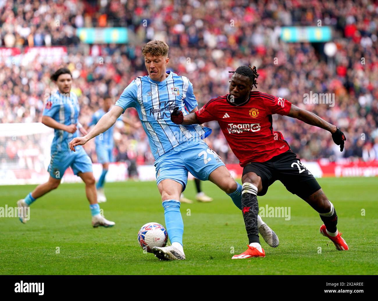 Coventry City's Victor Torp (left) and Manchester United's Aaron Wan ...