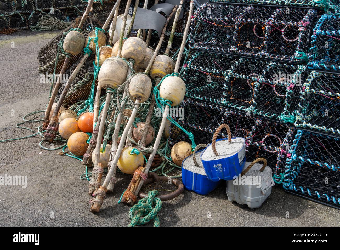 Harbour view with floats and lobster pots in the Scottish fishing town ...