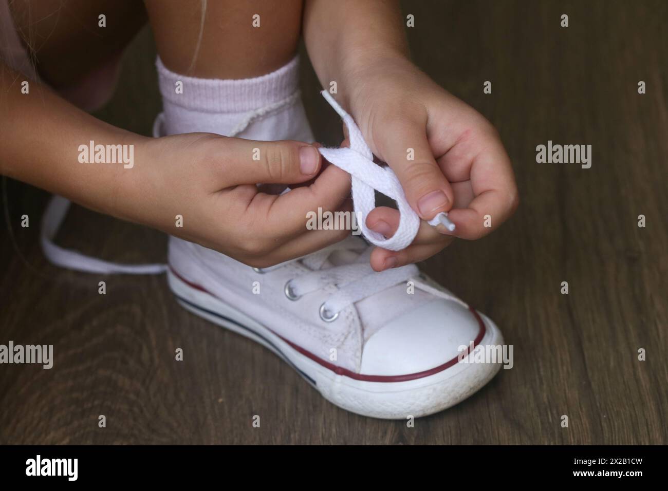 Kid tying shoes. Little girl struggling to tie shoe laces. Child ...