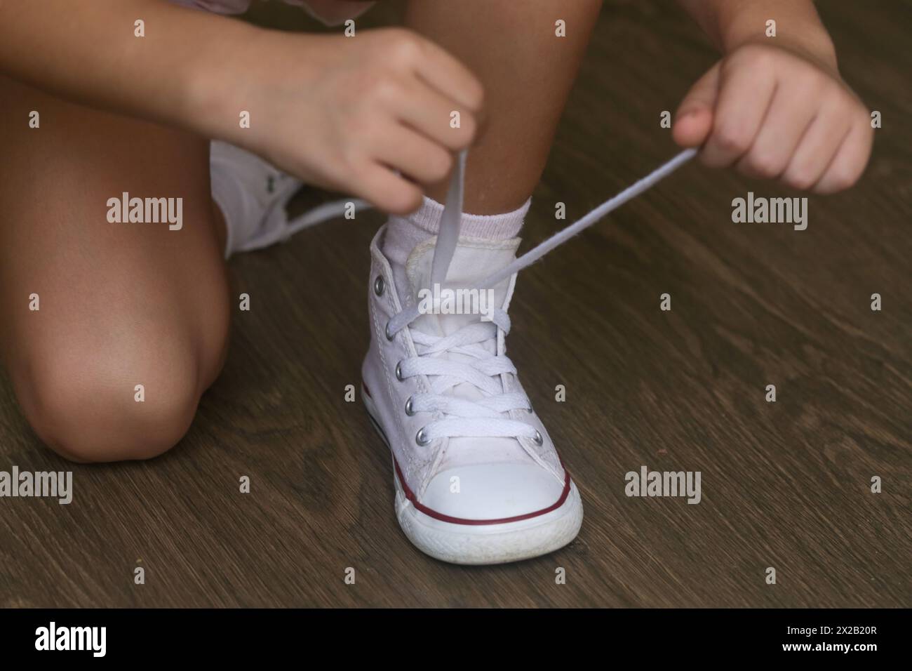 Kid tying shoes. Little girl struggling to tie shoe laces. Child ...