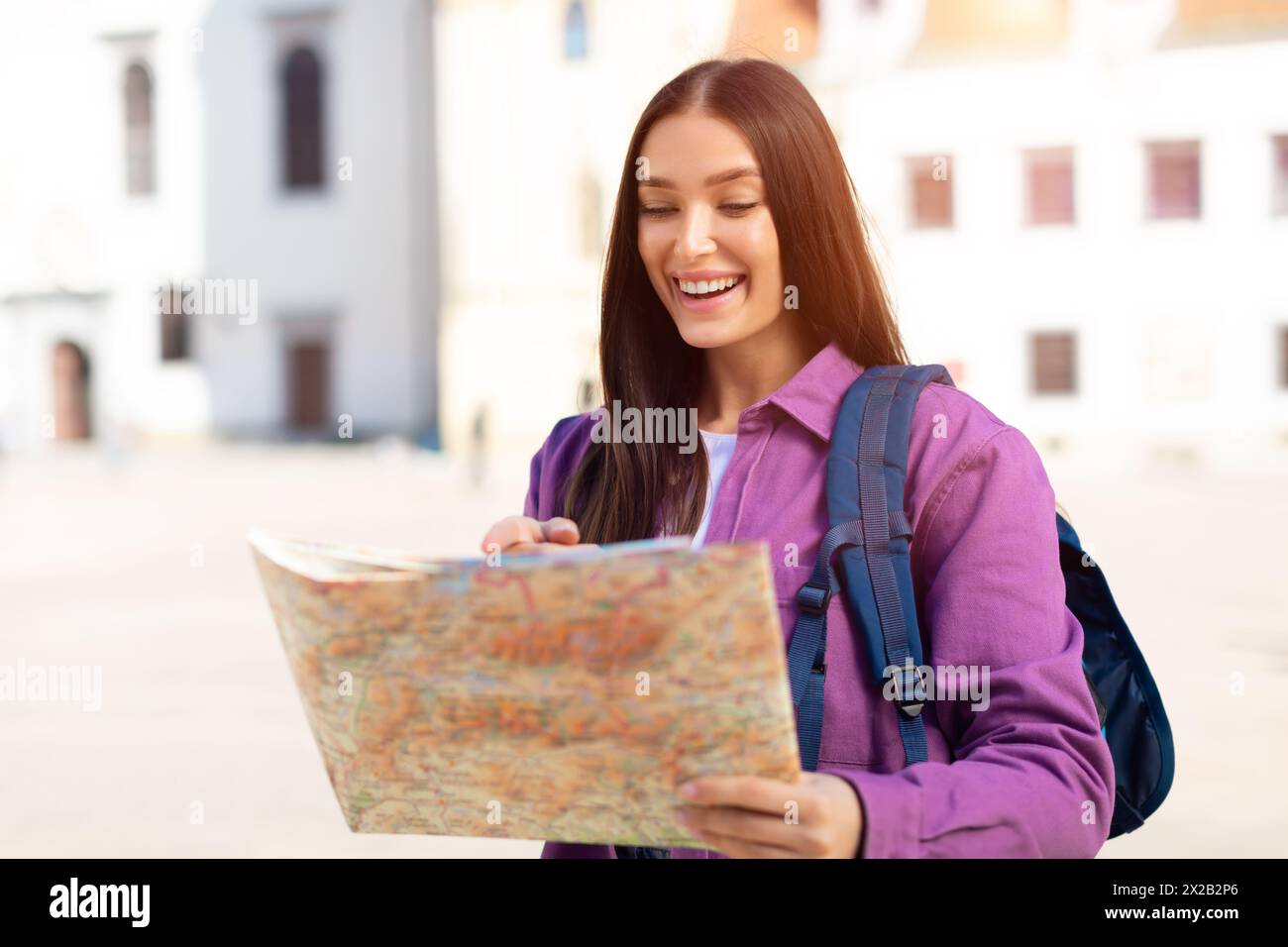 Woman smiling reading map hi-res stock photography and images - Alamy